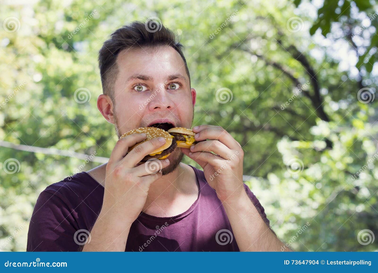 Man eating a hamburger stock photo. Image of greed, cheeseburger - 73647904