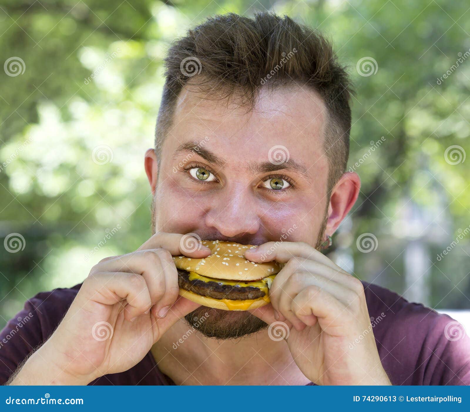Man eating a hamburger stock image. Image of expression - 74290613