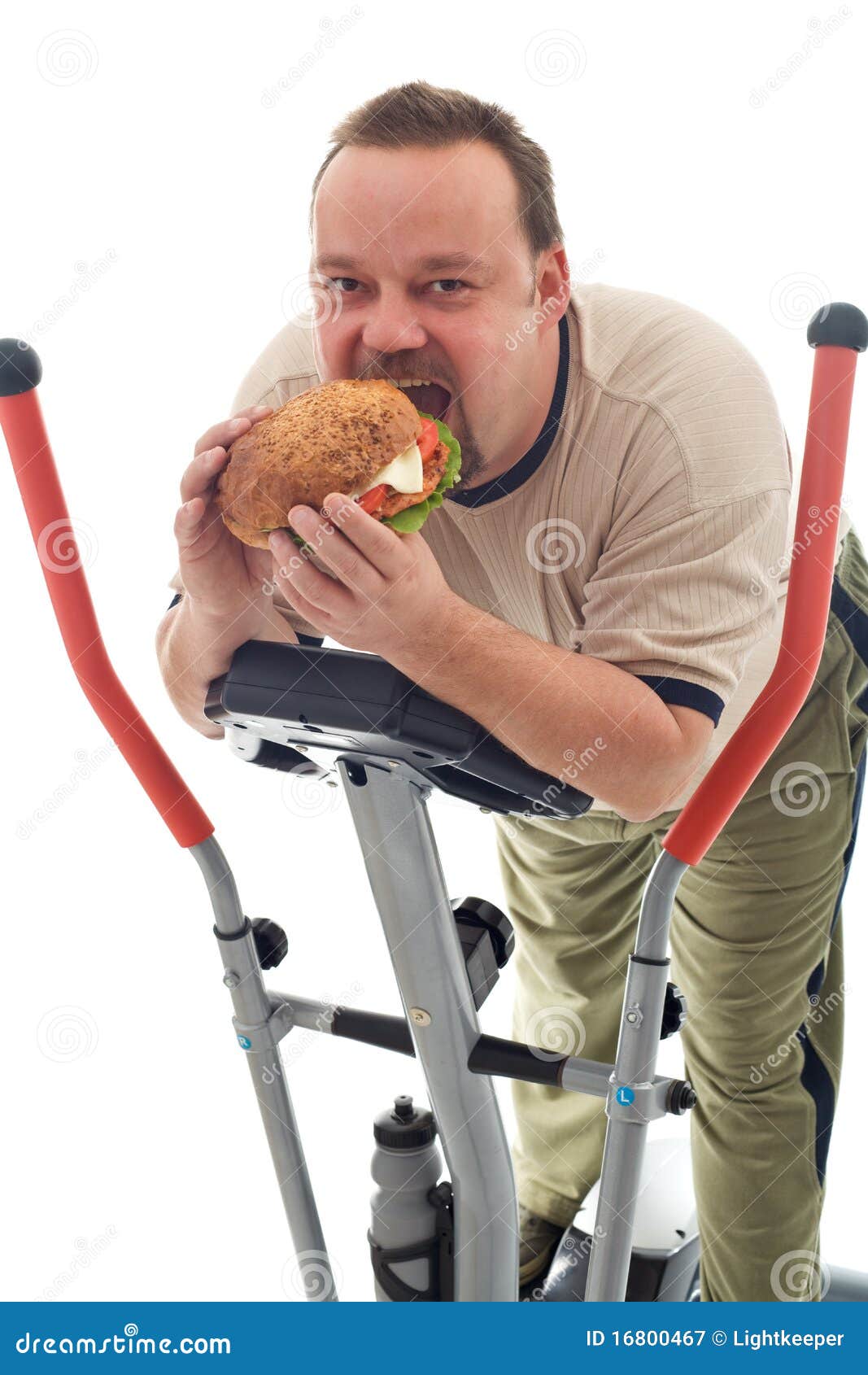 Man Eating Huge Hamburger on a Trainer Device Stock Image - Image of ...