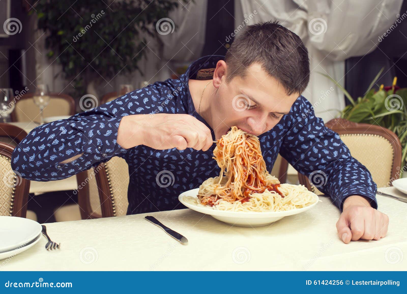 Man Eating a Large Portion of Pasta Stock Photo - Image of couple, fine ...