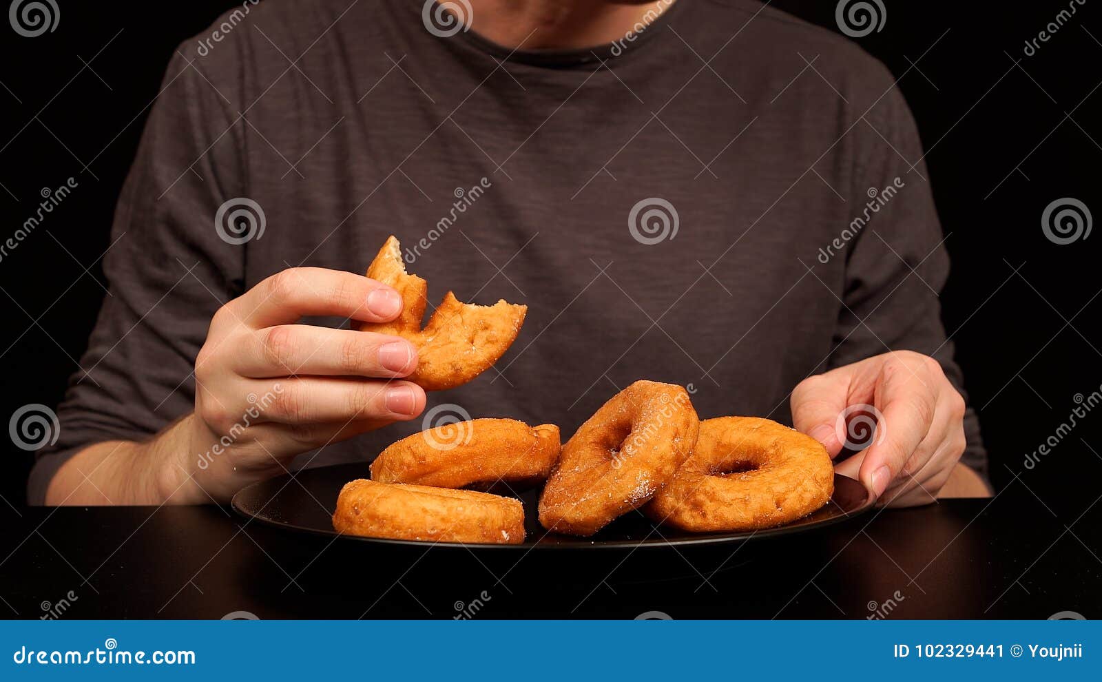 Man Eating a Lot of Doughnuts Stock Image - Image of adult, heap: 102329441