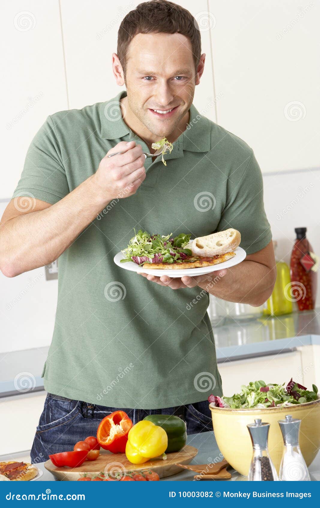 Man Eating Meal in Kitchen stock photo. Image of healthy - 10003082