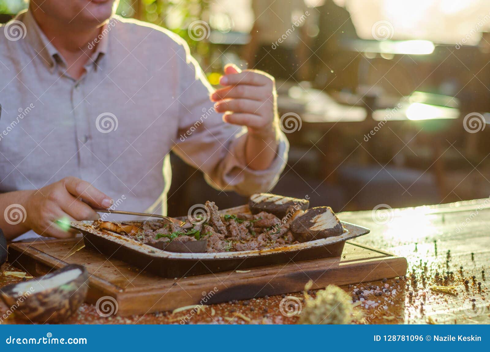 The Man is Eating Meat in the Restaurant. Stock Photo - Image of hungry ...