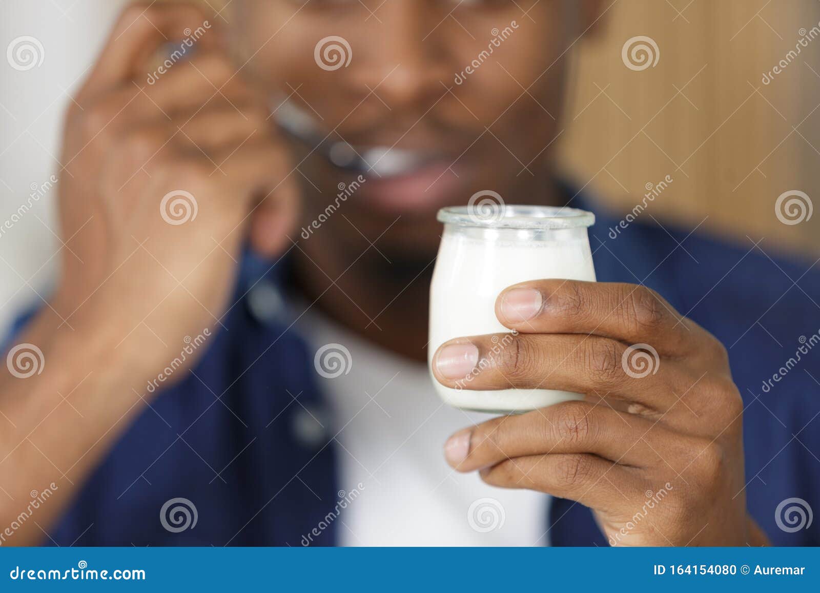 Man eating natural yogurt stock photo. Image of ethnic - 164154080