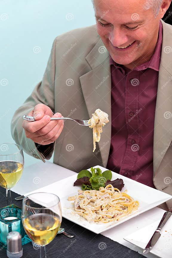 Man Eating Pasta in a Restaurant Stock Photo - Image of fork, italian ...