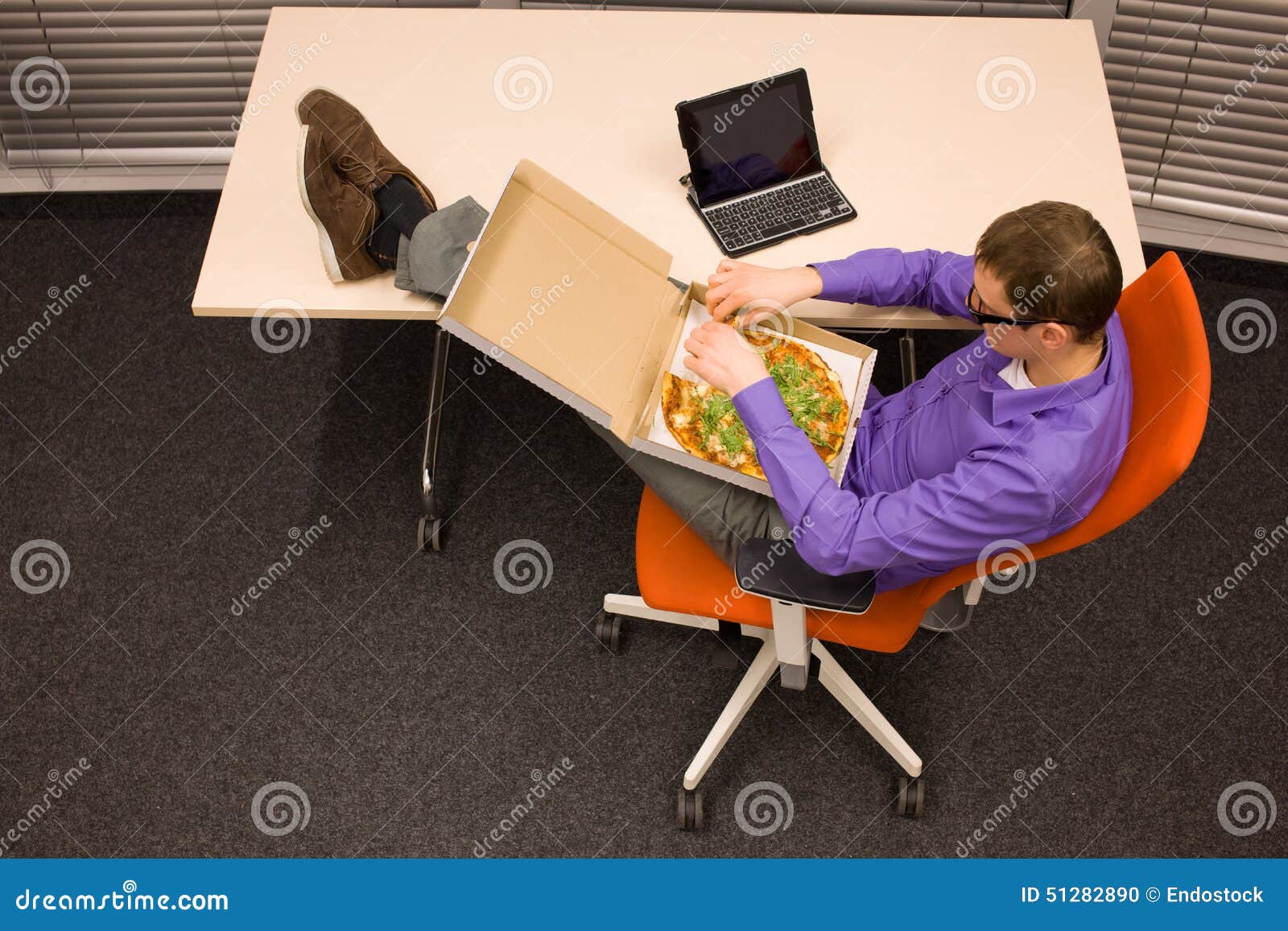 Man eating pizza in office stock photo. Image of body - 51282890