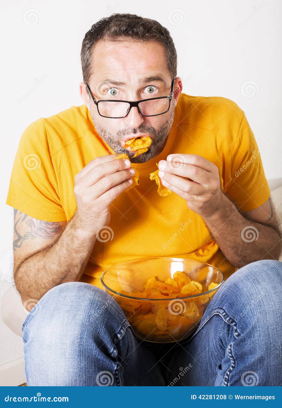 Man eating potato chips stock photo. Image of loathing - 42281208