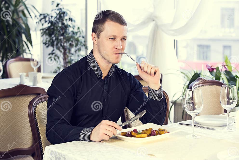 Man eating in a restaurant stock image. Image of cafe - 40603627