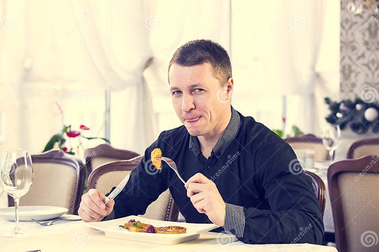 Man eating in a restaurant stock image. Image of male - 40603641