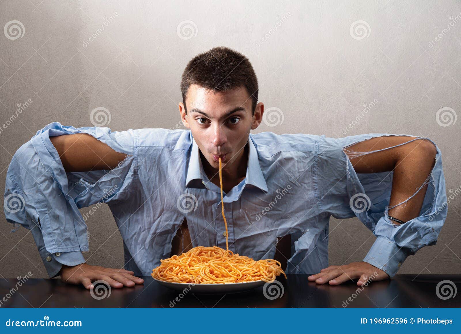 Man Eating Spaghetti with Tomato Sauce Stock Photo - Image of ...