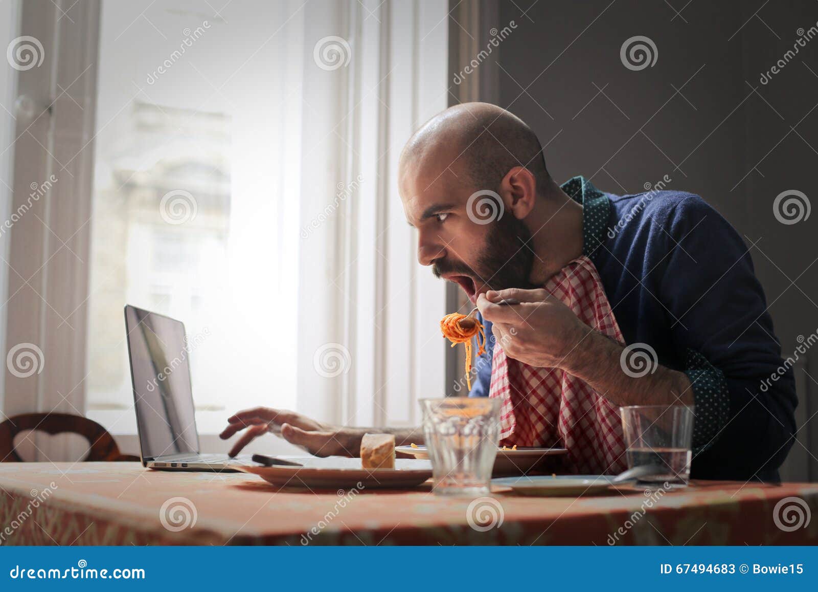 Man Eating Spaghetti and Using Computer Stock Image - Image of table ...