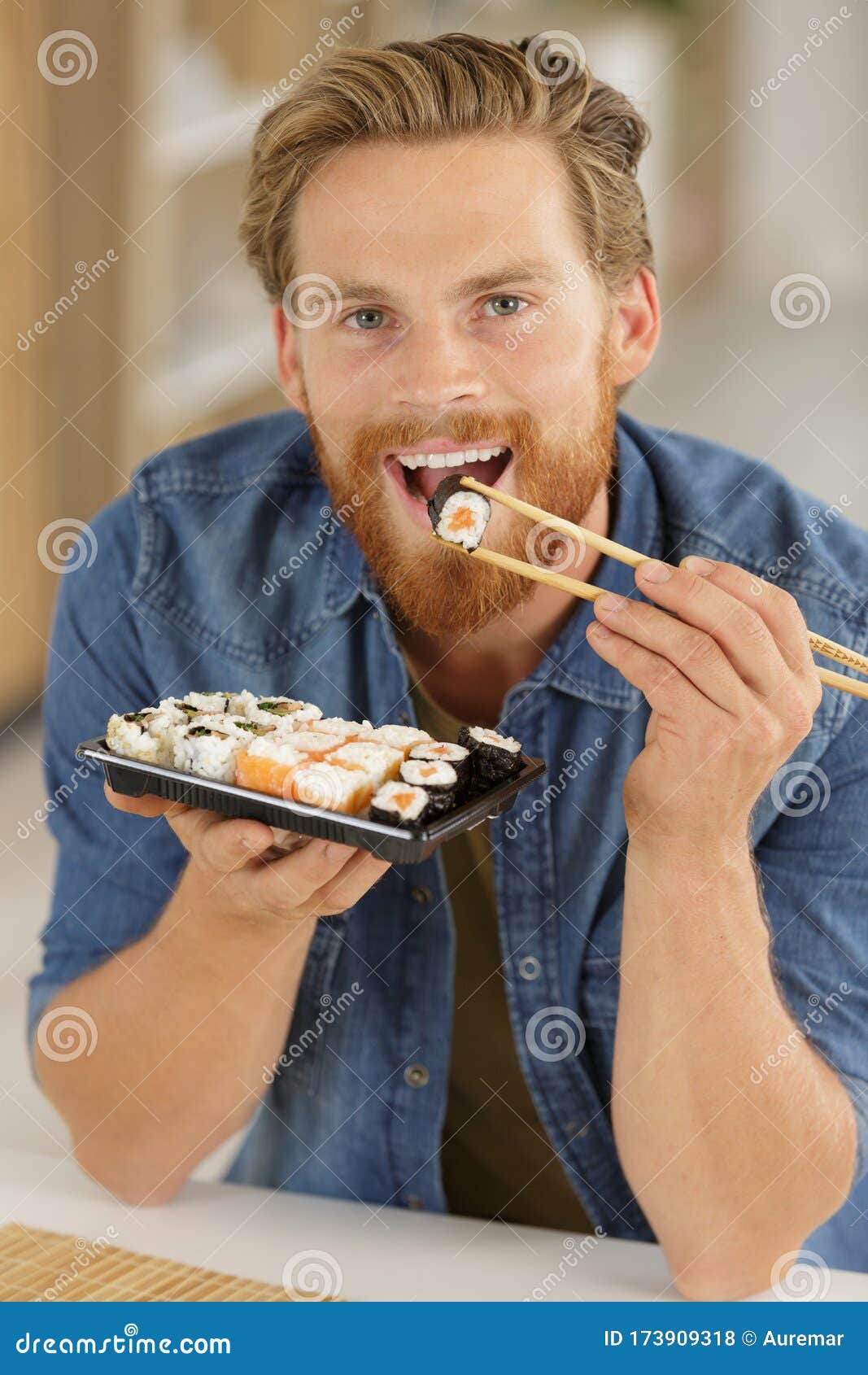 Man Eating Sushi with Chopstic Stock Photo - Image of dish, slice ...