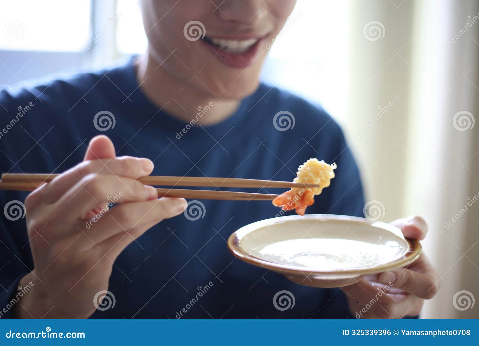 A Man Eating the Tail of a Shrimp Tempura Stock Photo - Image of smile ...