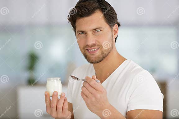 Man eating yogurt stock image. Image of dairy, blackhaired - 309076853