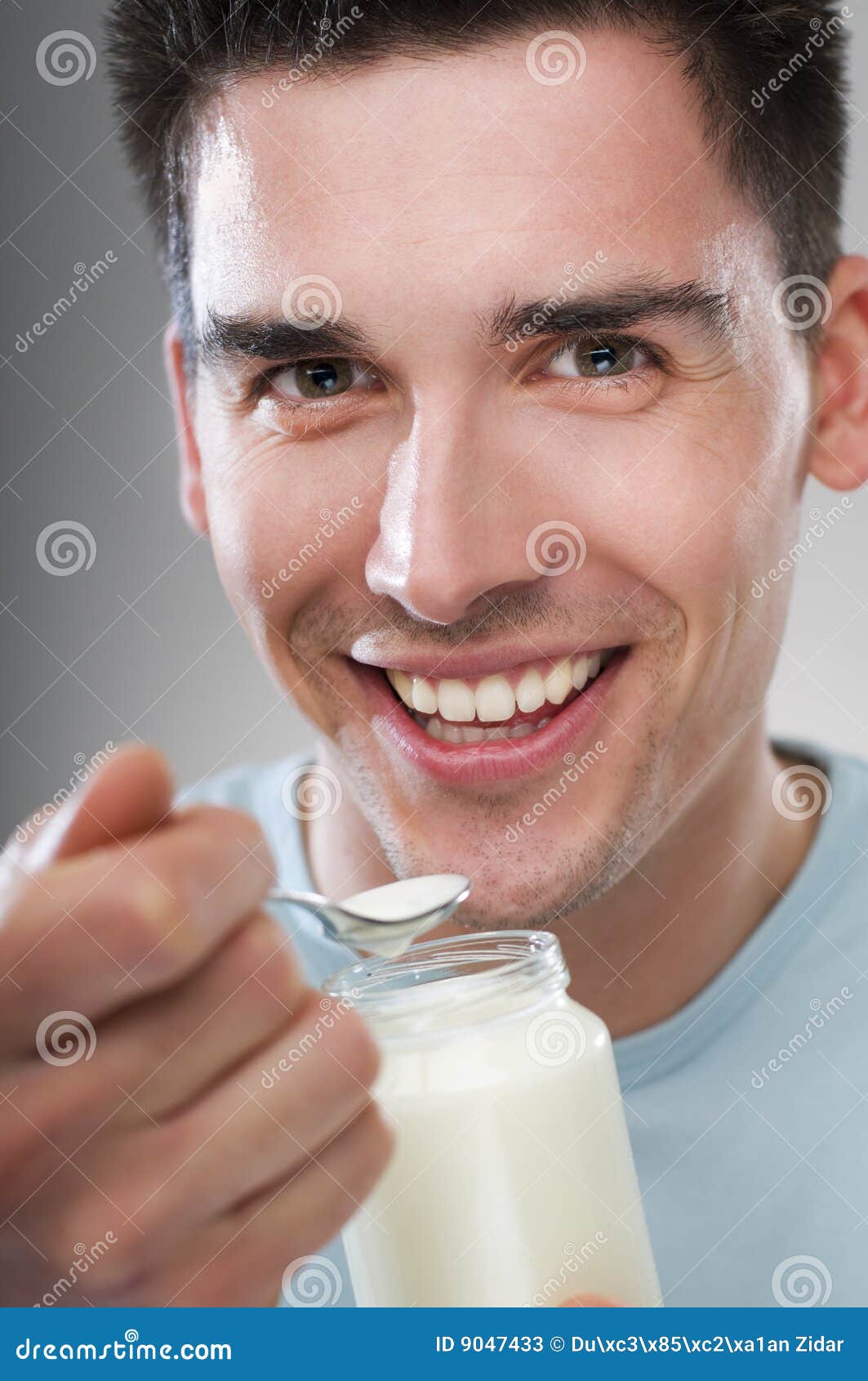 Man eating yogurt stock image. Image of hair, looking - 9047433