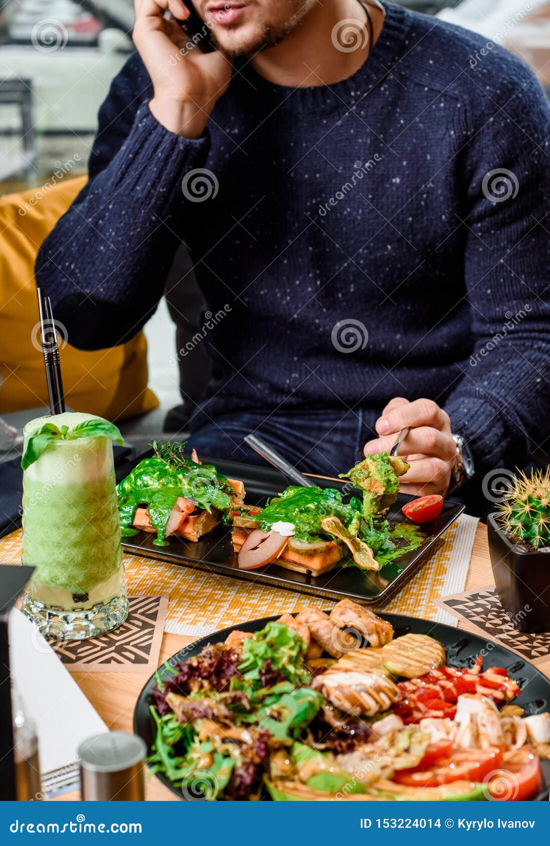 Man Eats Waffles with Ham, Cheese, Eggs, Tomatoes and Spinach Sauce and ...