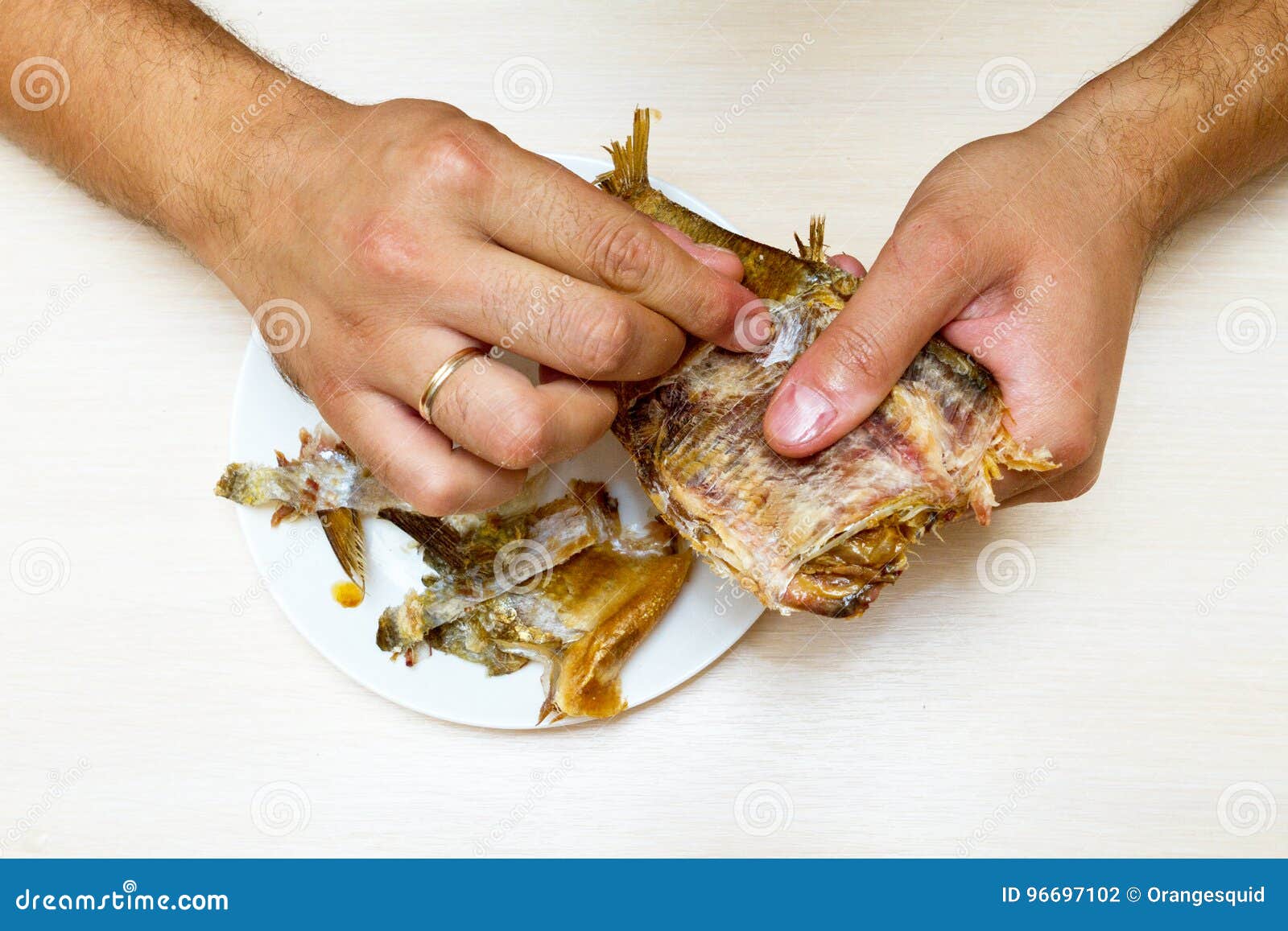 The man eats dried fish. stock photo. Image of eats, diet - 96697102