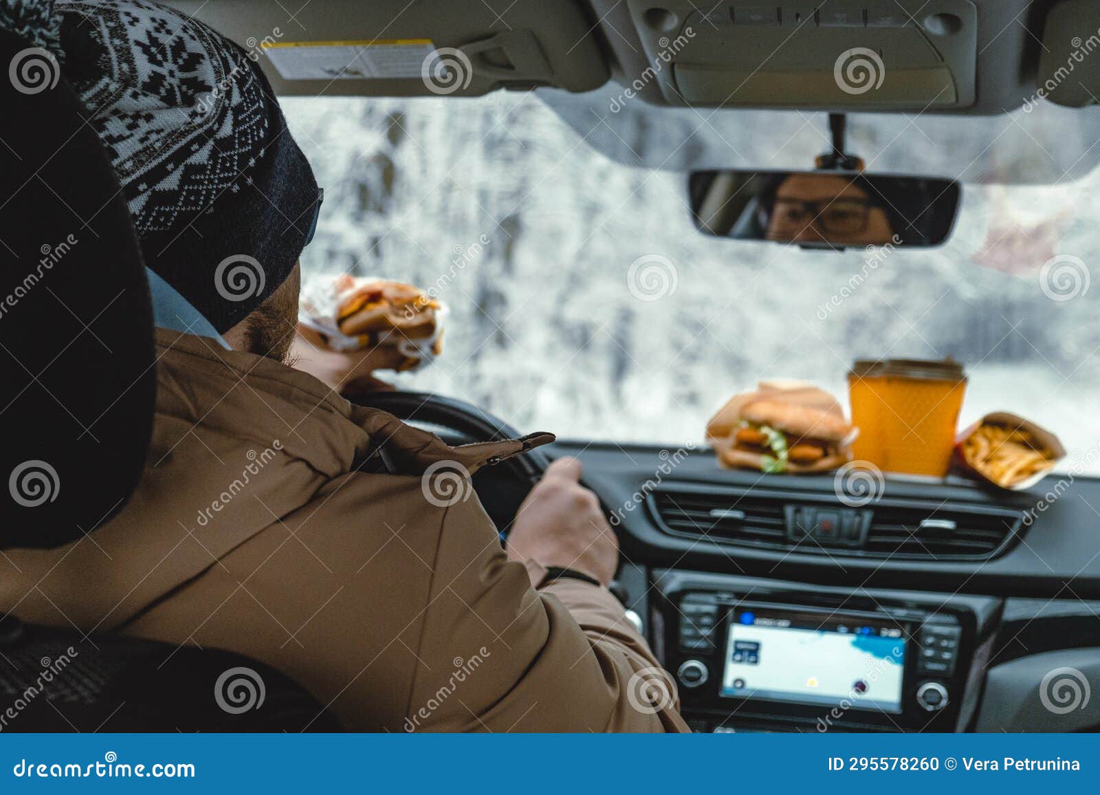 A Man Eats while Driving a Car. Stop for Lunch Stock Photo - Image of ...
