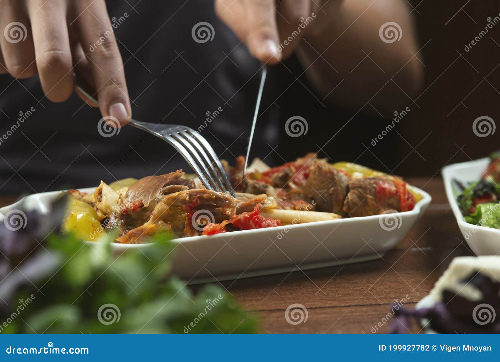 Man Eats Lamb Stew on the Bone with Vegetables Stock Photo - Image of ...