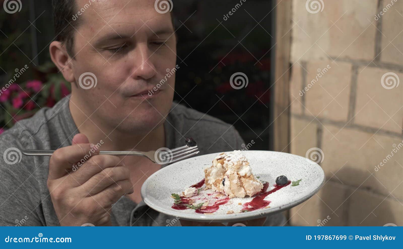 Man eating meringue roll stock image. Image of diet - 197867699