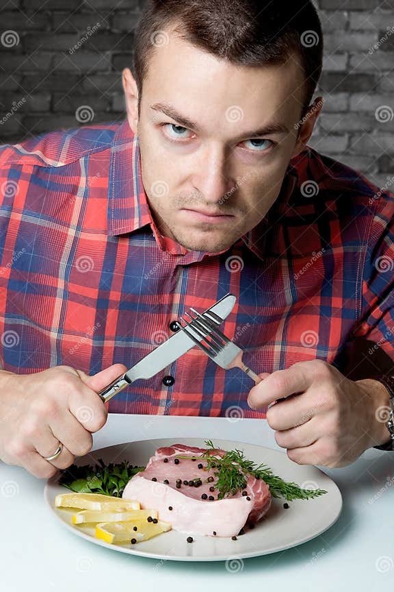 Man eats raw meat stock photo. Image of steak, cooking - 85046388