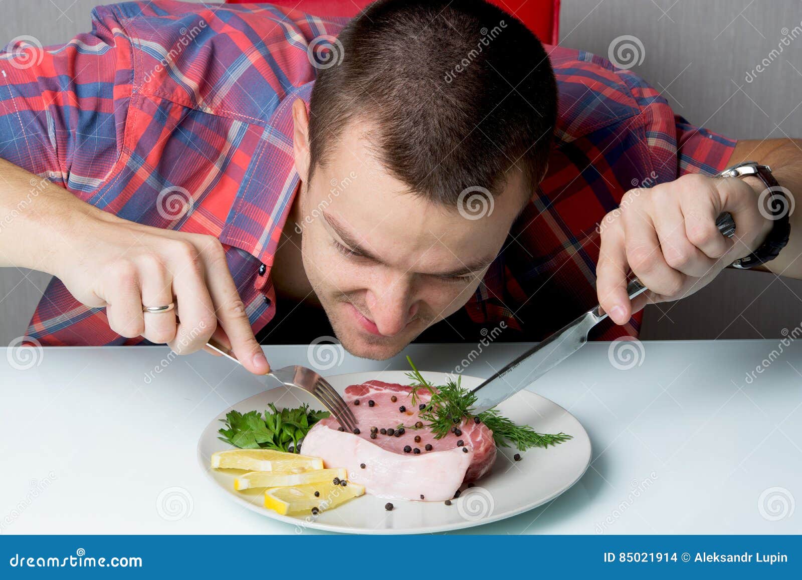 Man eats raw meats stock photo. Image of steak, hungry - 85021914