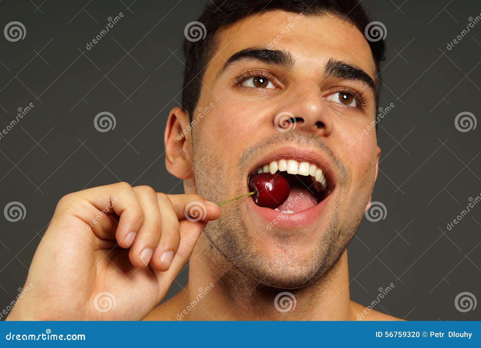Man eats red fresh cherry stock photo. Image of cheerful - 56759320