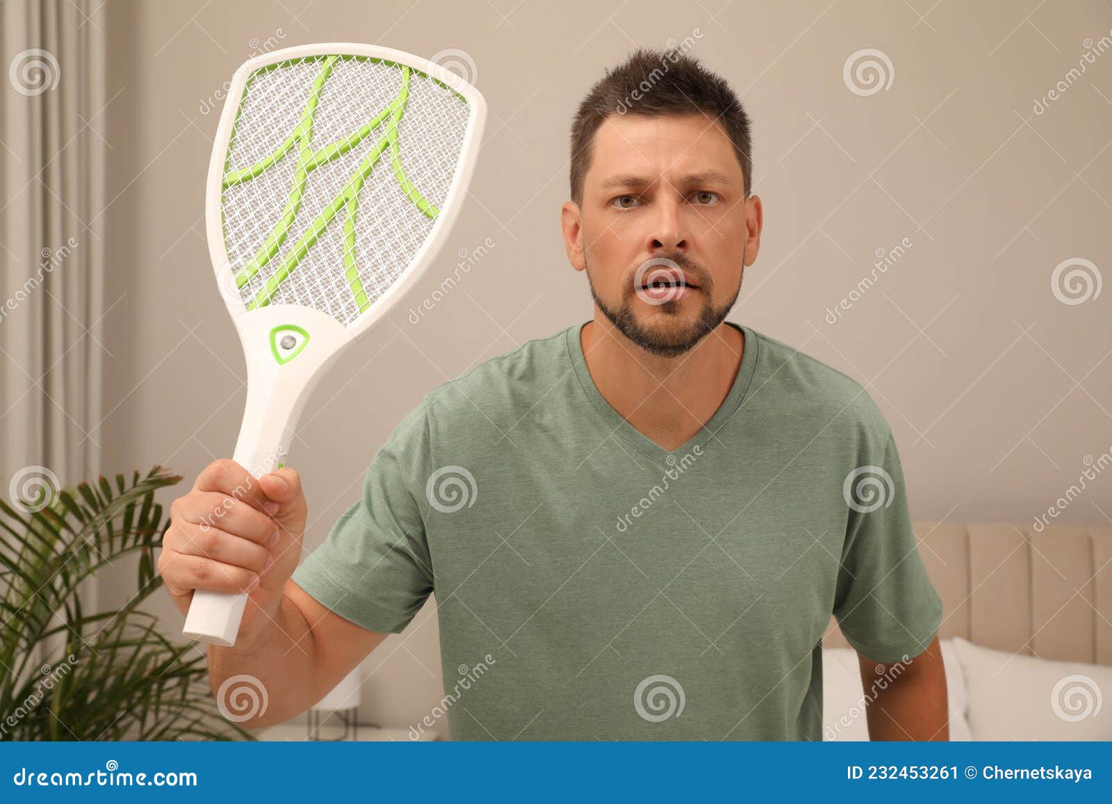 Man with Electric Fly Swatter in Bedroom. Insect Killer Stock Image ...
