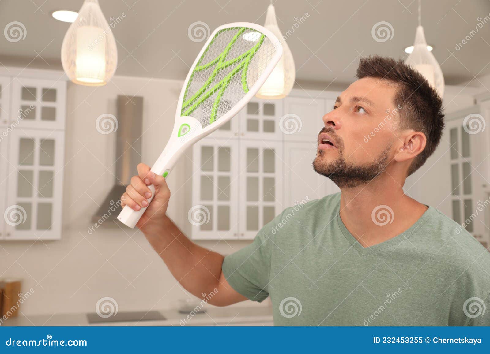 Man with Electric Fly Swatter in Kitchen. Insect Killer Stock Image ...