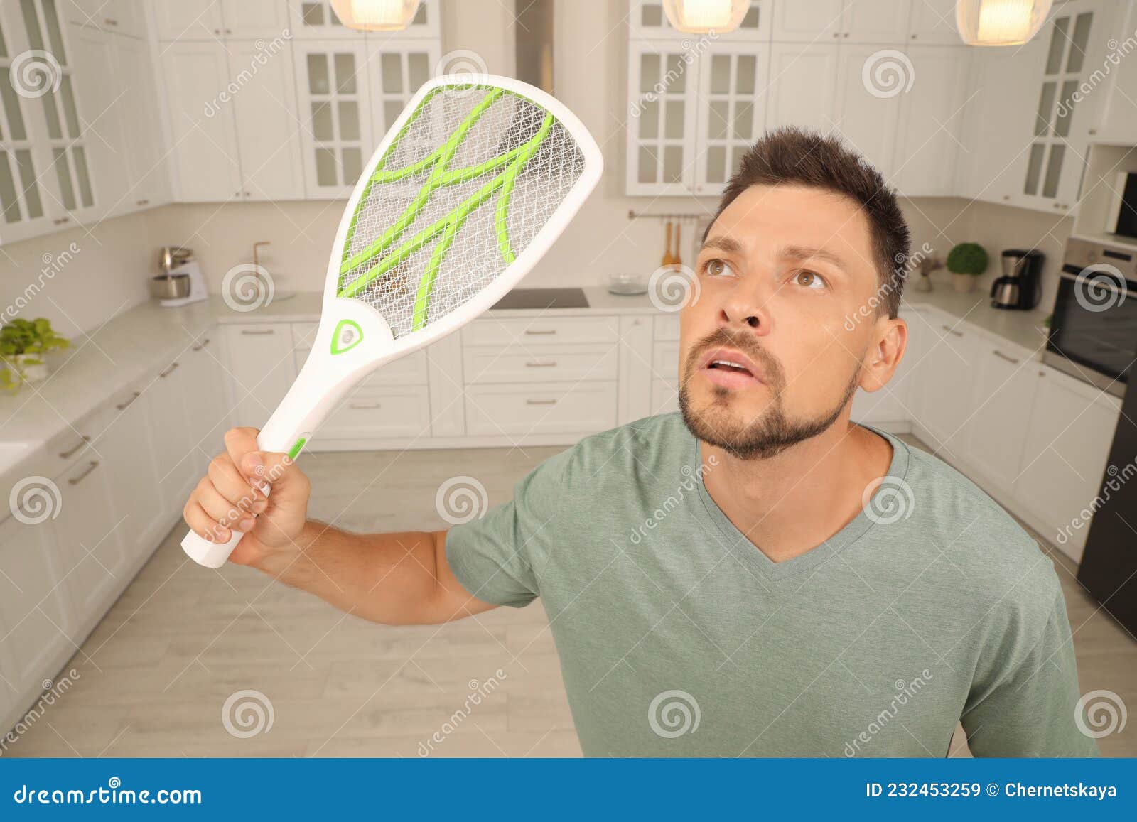 Man with Electric Fly Swatter in Kitchen. Insect Killer Stock Image ...