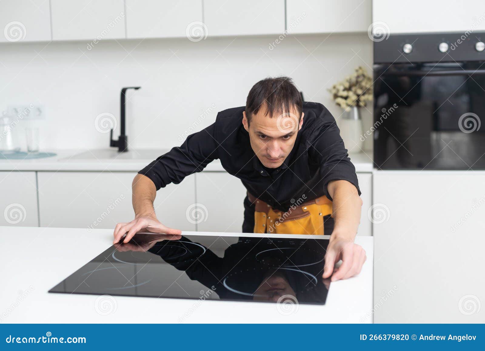 Man Electrical Repairs Kitchen Surface Apartment. Installing Hob in ...