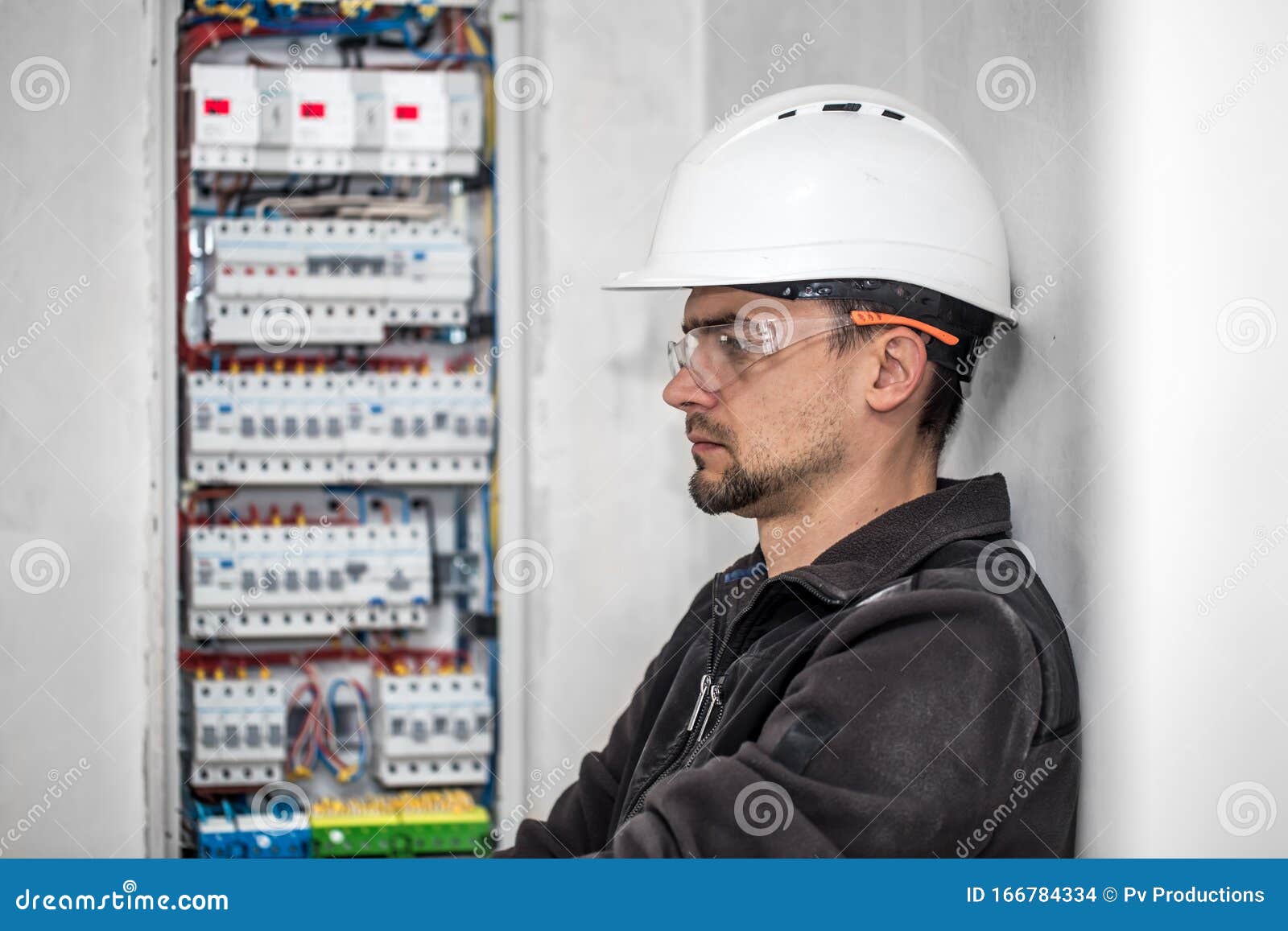Man, An Electrical Technician Working In A Switchboard With Fuses ...