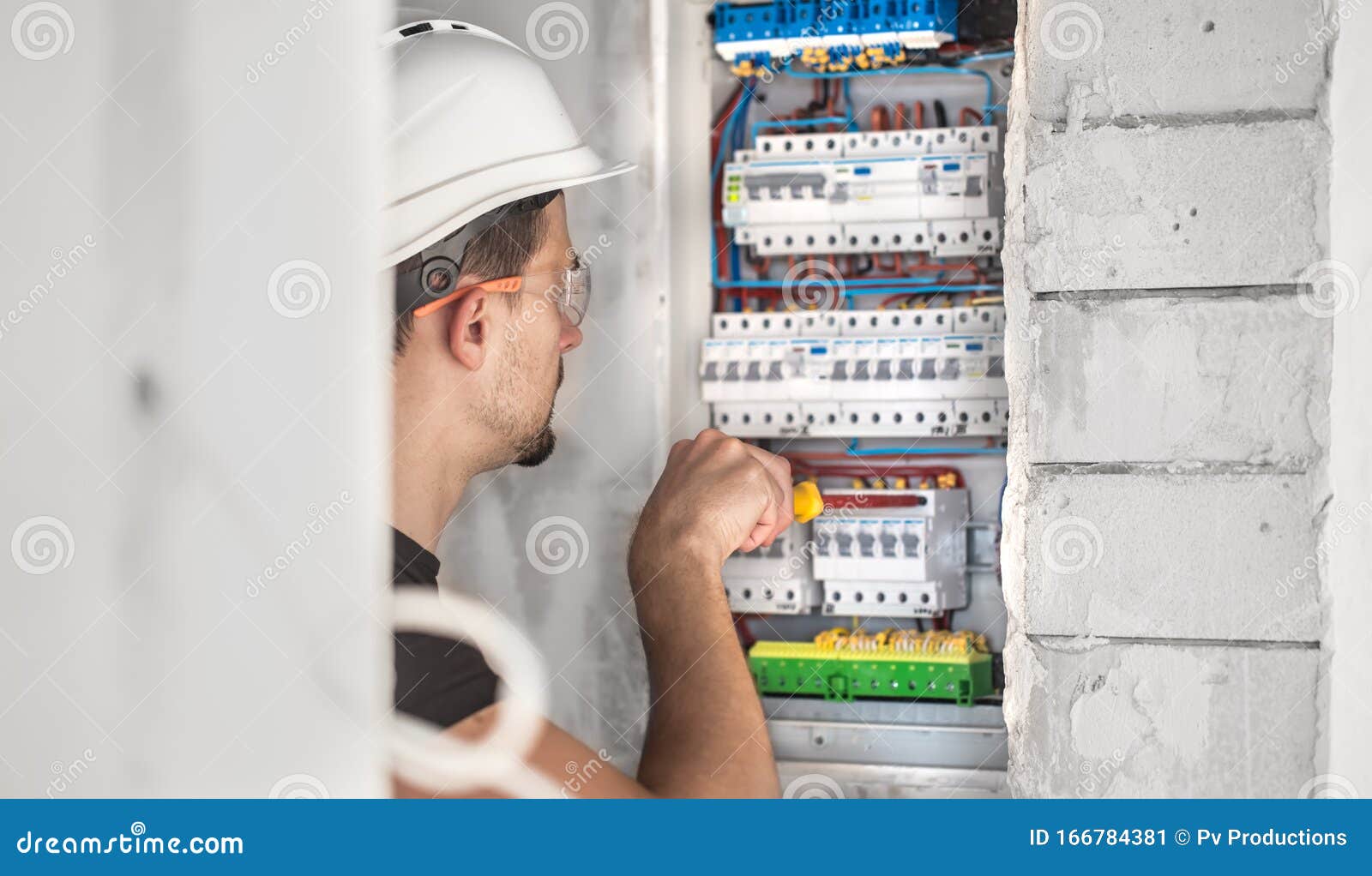 Man, an Electrical Technician Working in a Switchboard with Fuses ...