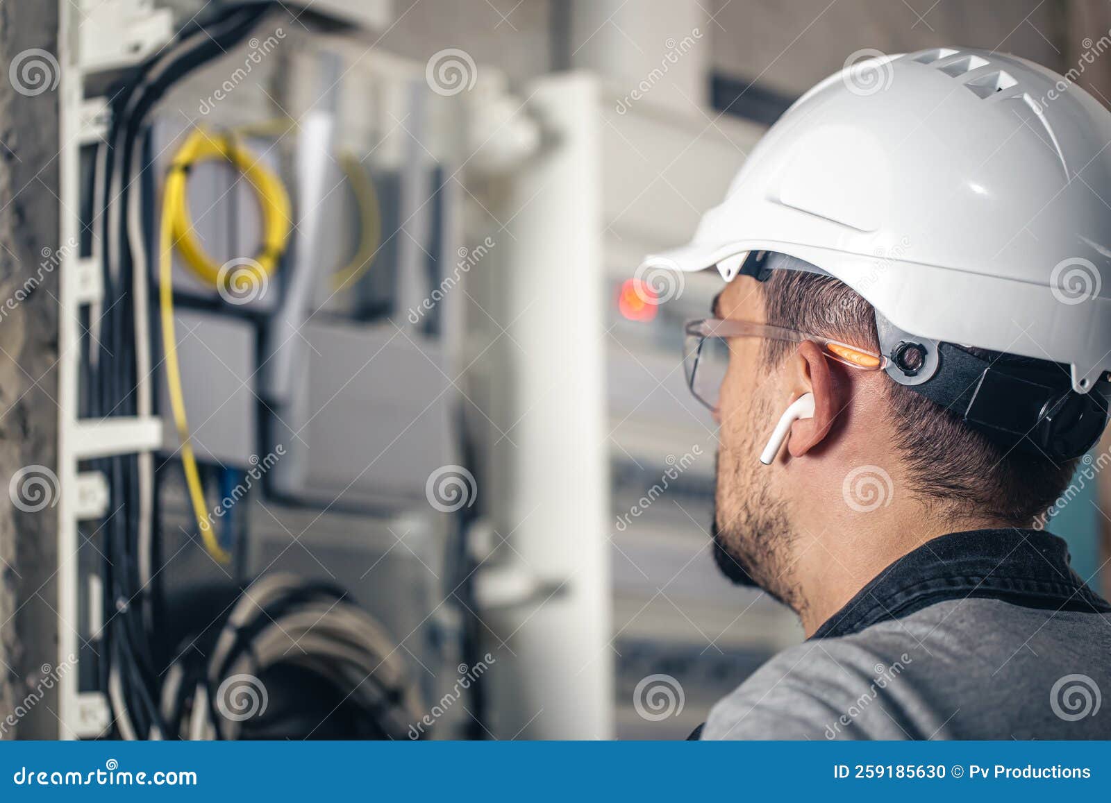 Man, an Electrical Technician Working in a Switchboard with Fuses ...