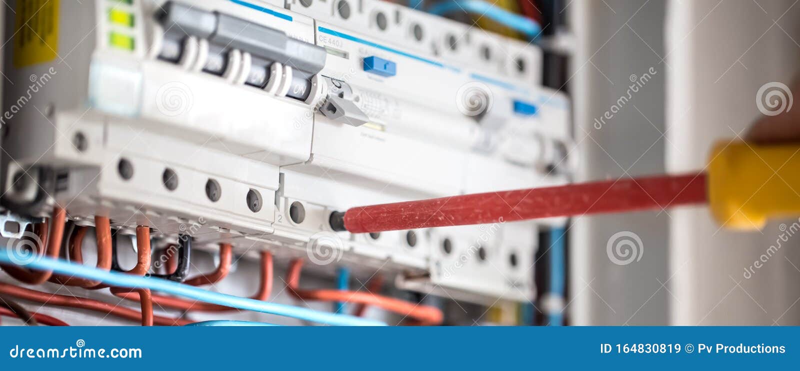 Man, an Electrical Technician Working in a Switchboard with Fuses ...