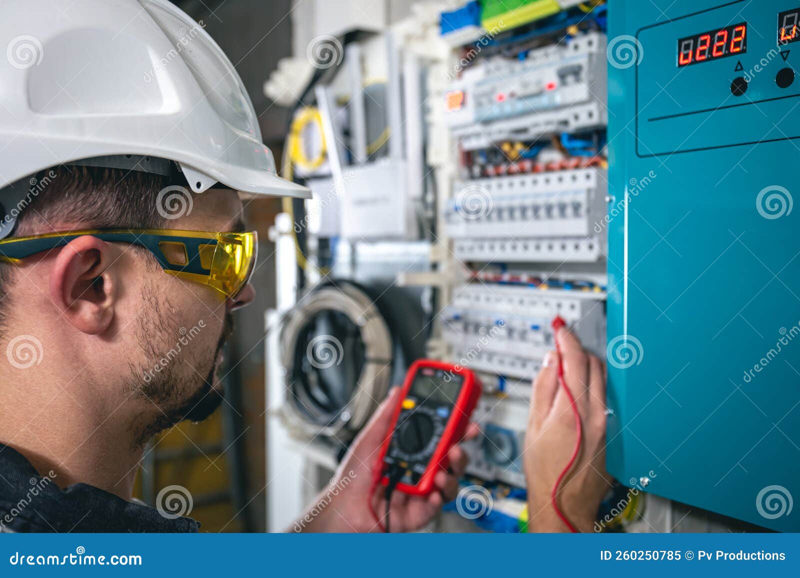 Man, an Electrical Technician Working in a Switchboard with Fuses ...
