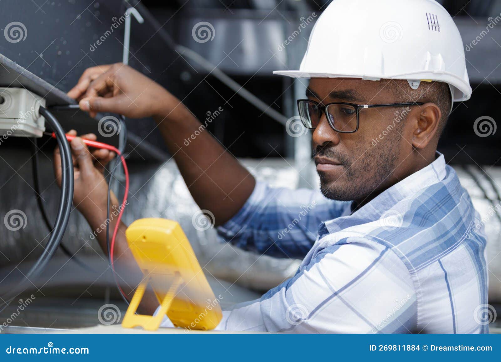 Man Electrician in Uniform and Helmet Checking Voltage Stock Photo ...