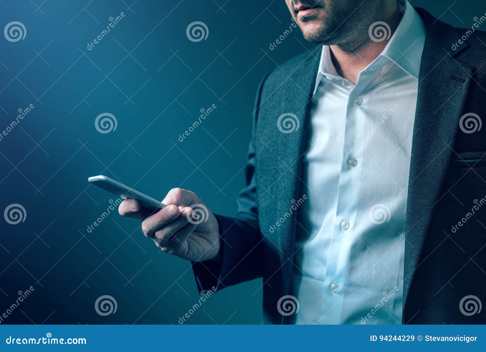 Man in Elegant Business Suit Looking at Mobile Phone Screen Stock Image ...