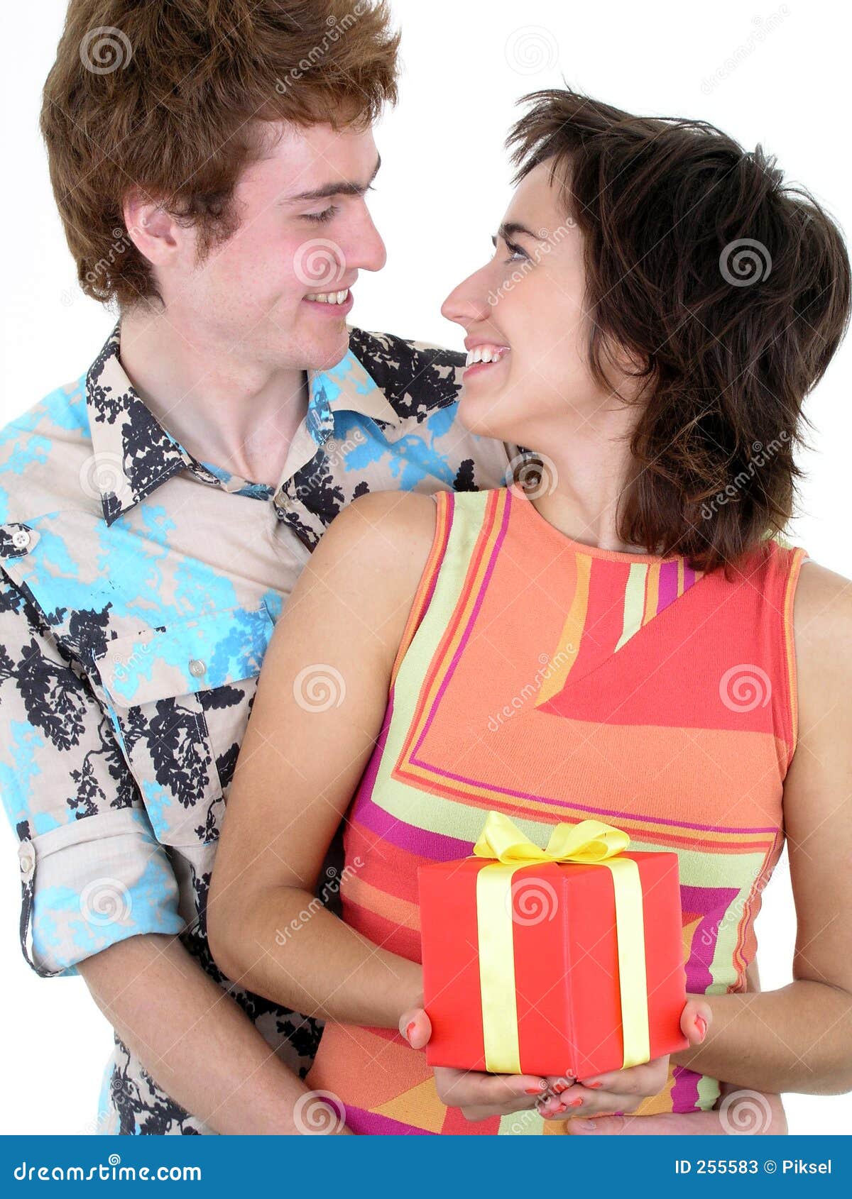 Man Embracing Woman As she Holds Present Stock Image - Image of present ...