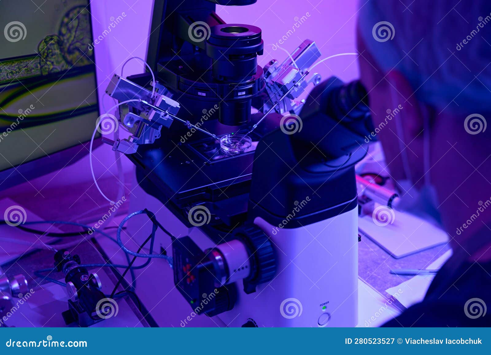 Man Embryologist Working with Micromanipulator Looking at Microscope ...