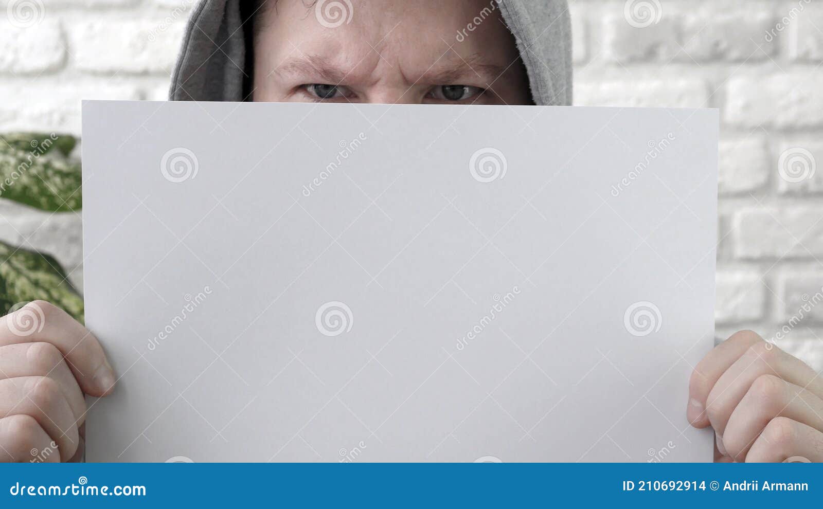 A Man with an Empty Sheet of Paper for a Text Set, a Poster for a Text ...