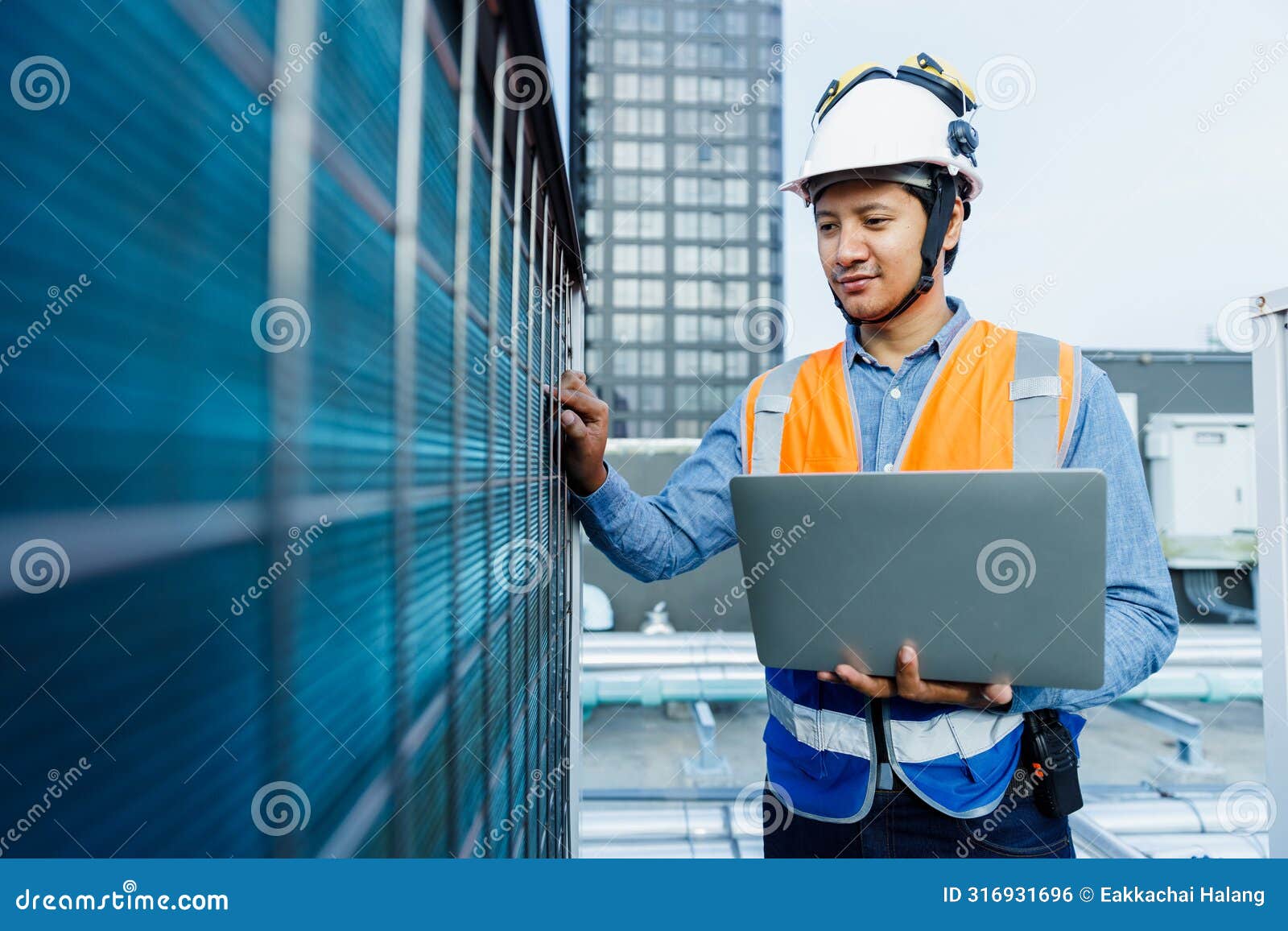 Man Engineer Holding Laptop Working at Rooftop Building Construction. Male Technician Worker ...