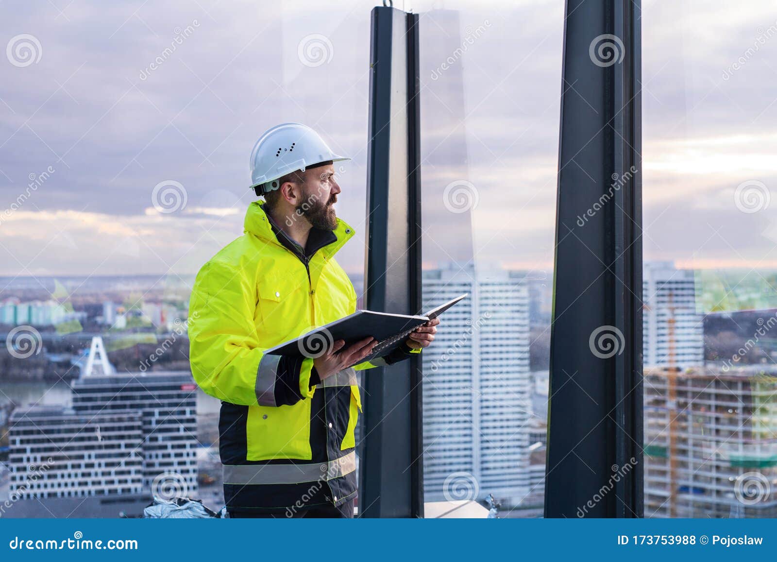 Man Engineer Standing on Construction Site, Holding Blueprints. Stock ...