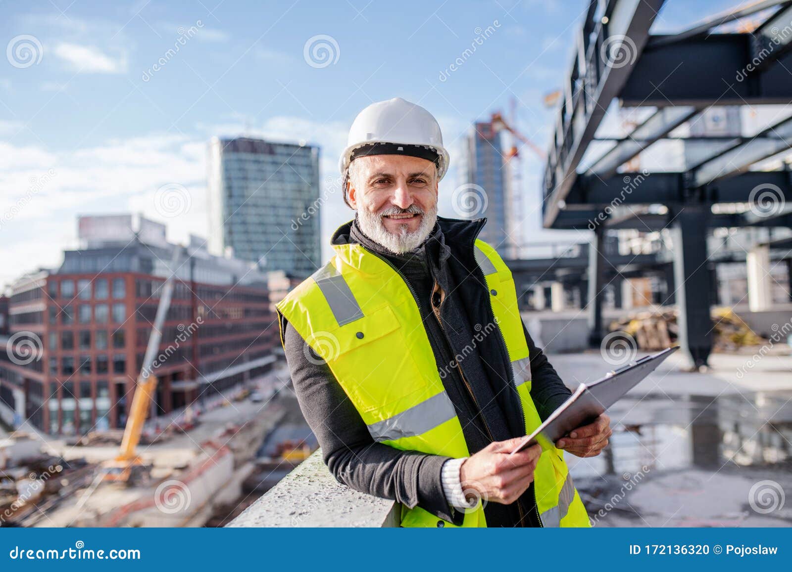 Man Engineer Standing Outdoors on Construction Site, Looking at Camera ...