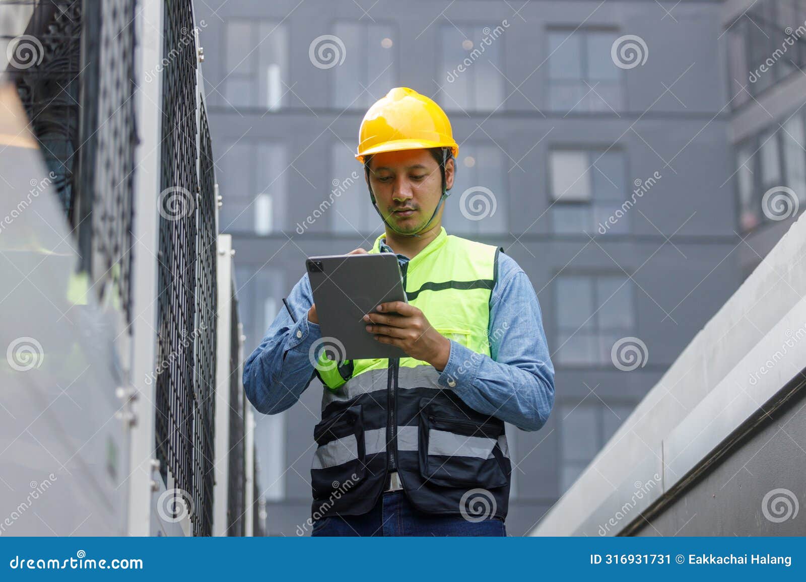 Man Engineer Using Tablet Working at Rooftop Building Construction. Male Technician Worker ...