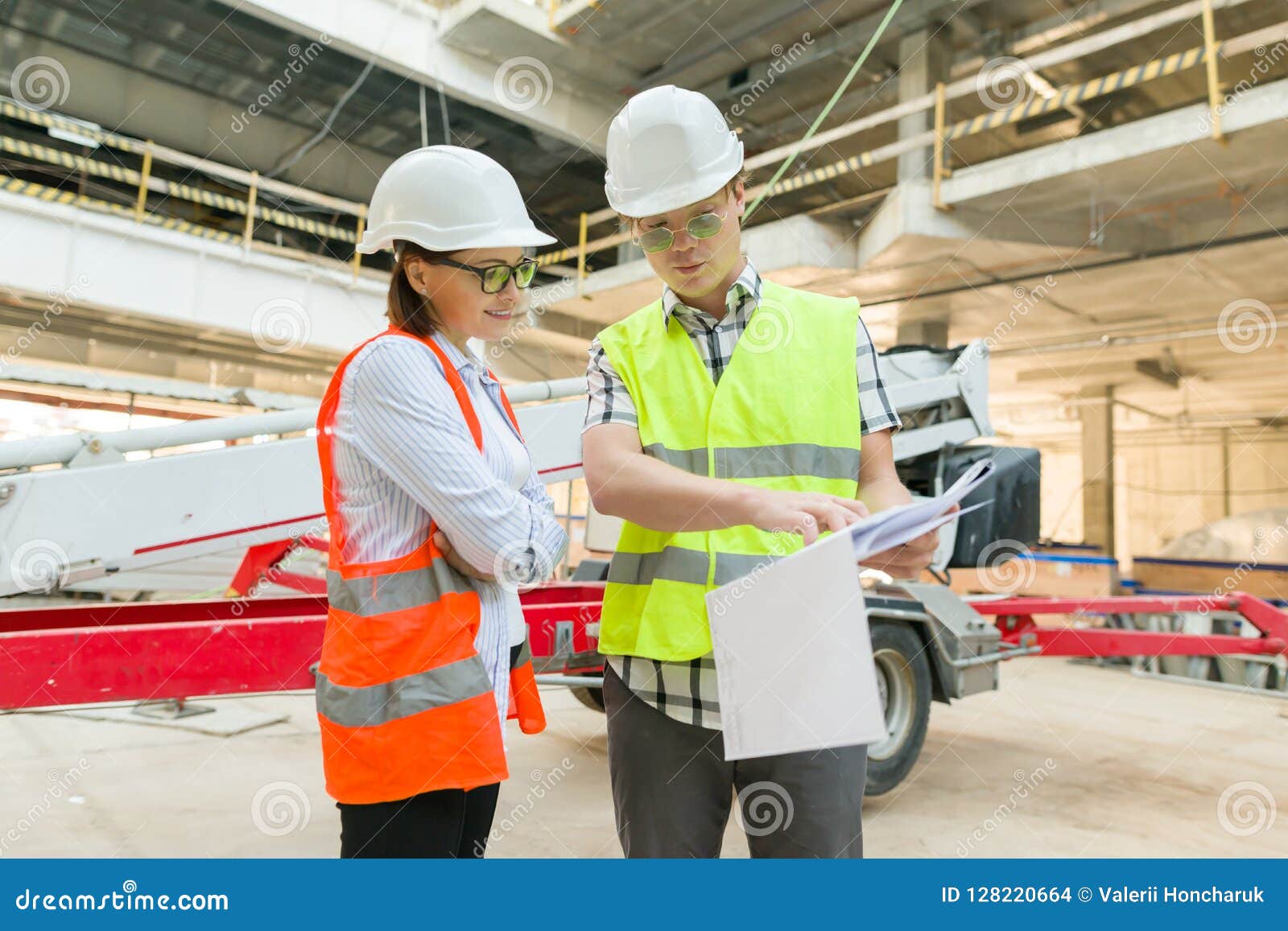 Man Engineer and Woman Architect at a Construction Site. Building ...