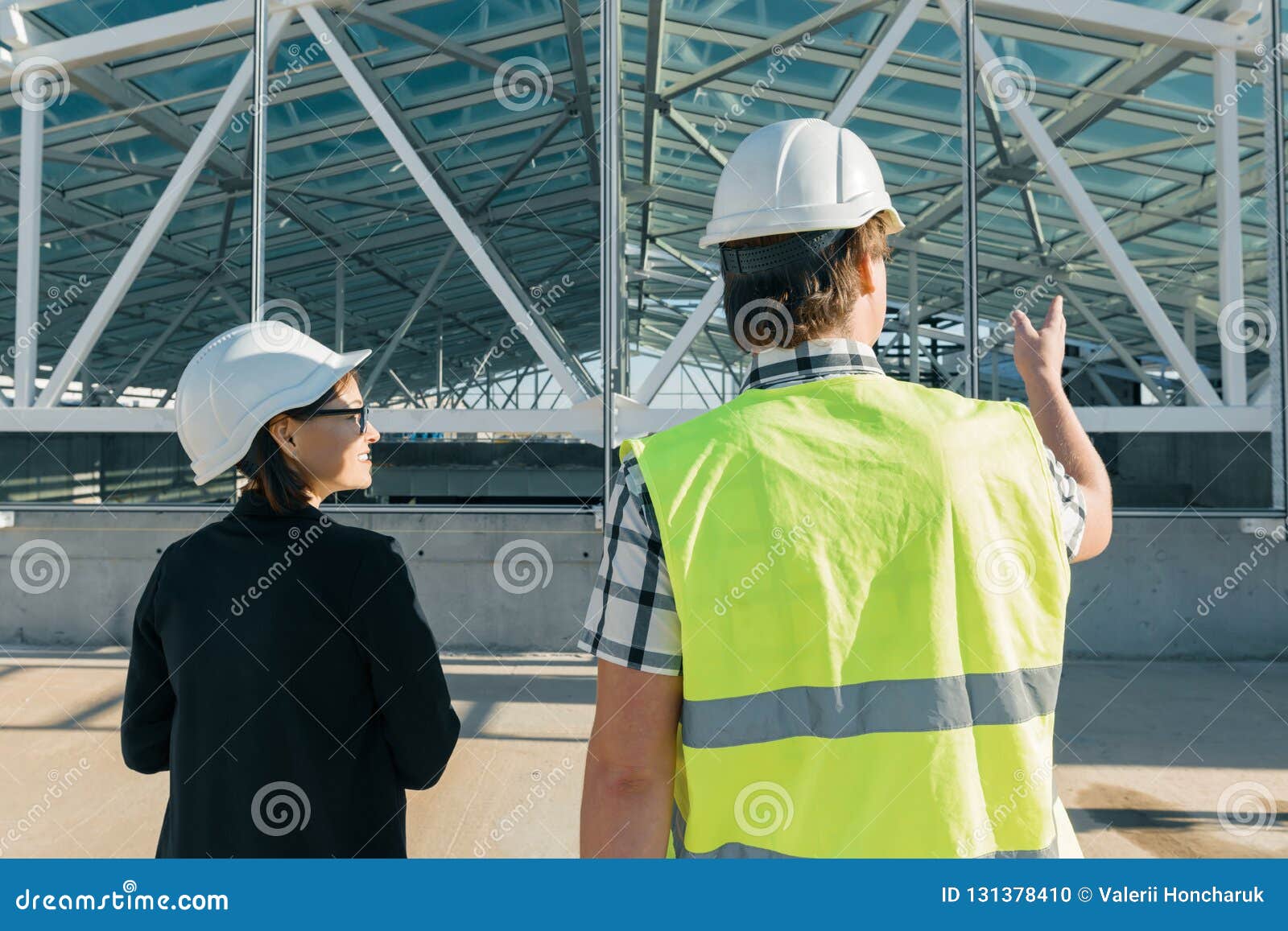 Man Engineer and Woman Architect at a Construction Site. Building ...