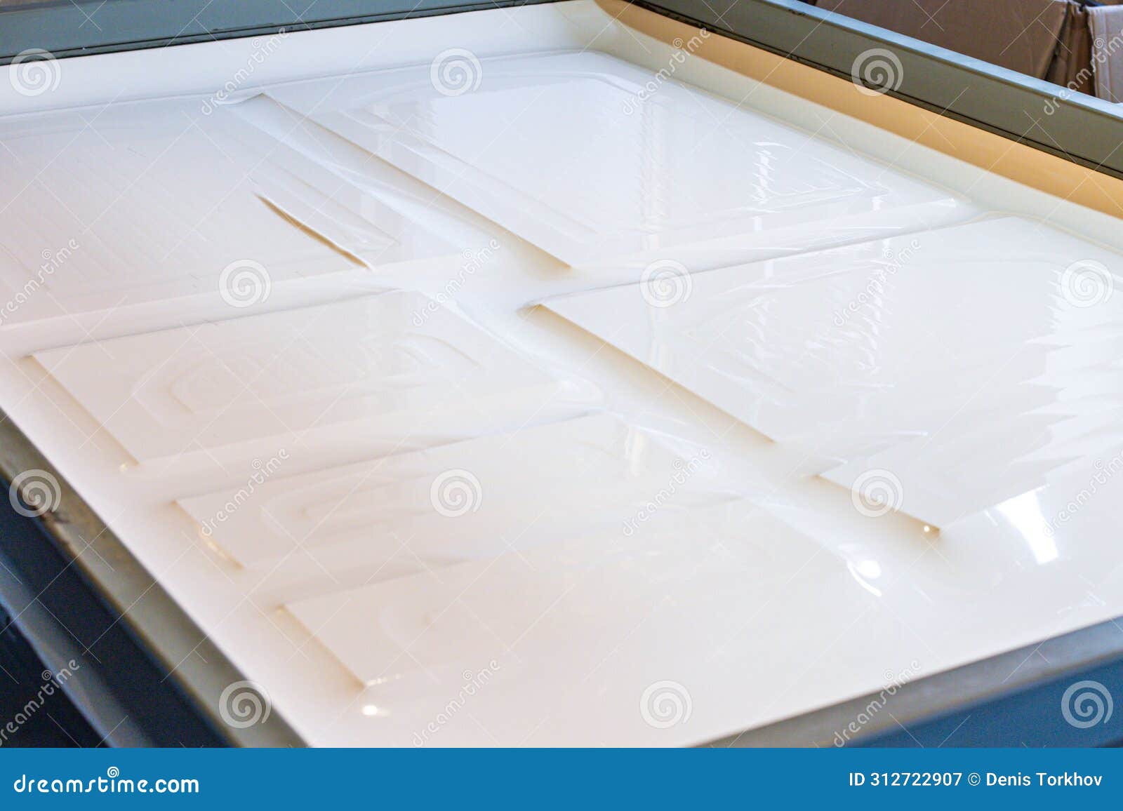 A Man Engineer Working on a Machine for Sticking a Film on an MDF Panel ...