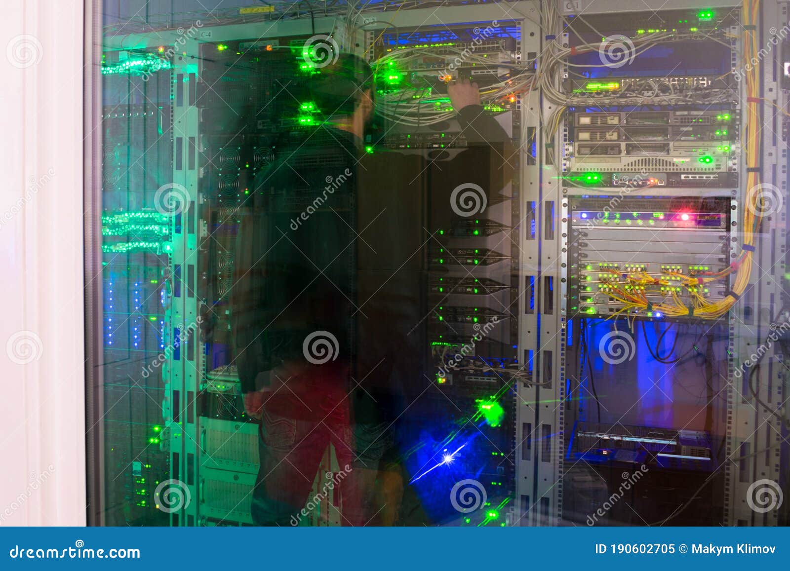 The Man Engineer Works in the Server Room of a Modern Data Center ...