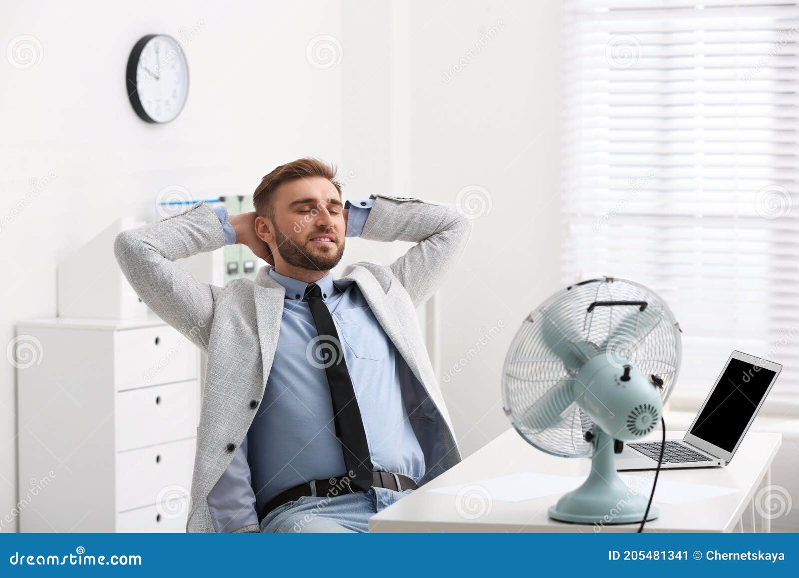Man Enjoying Air Flow from Fan at Workplace Stock Image - Image of ...